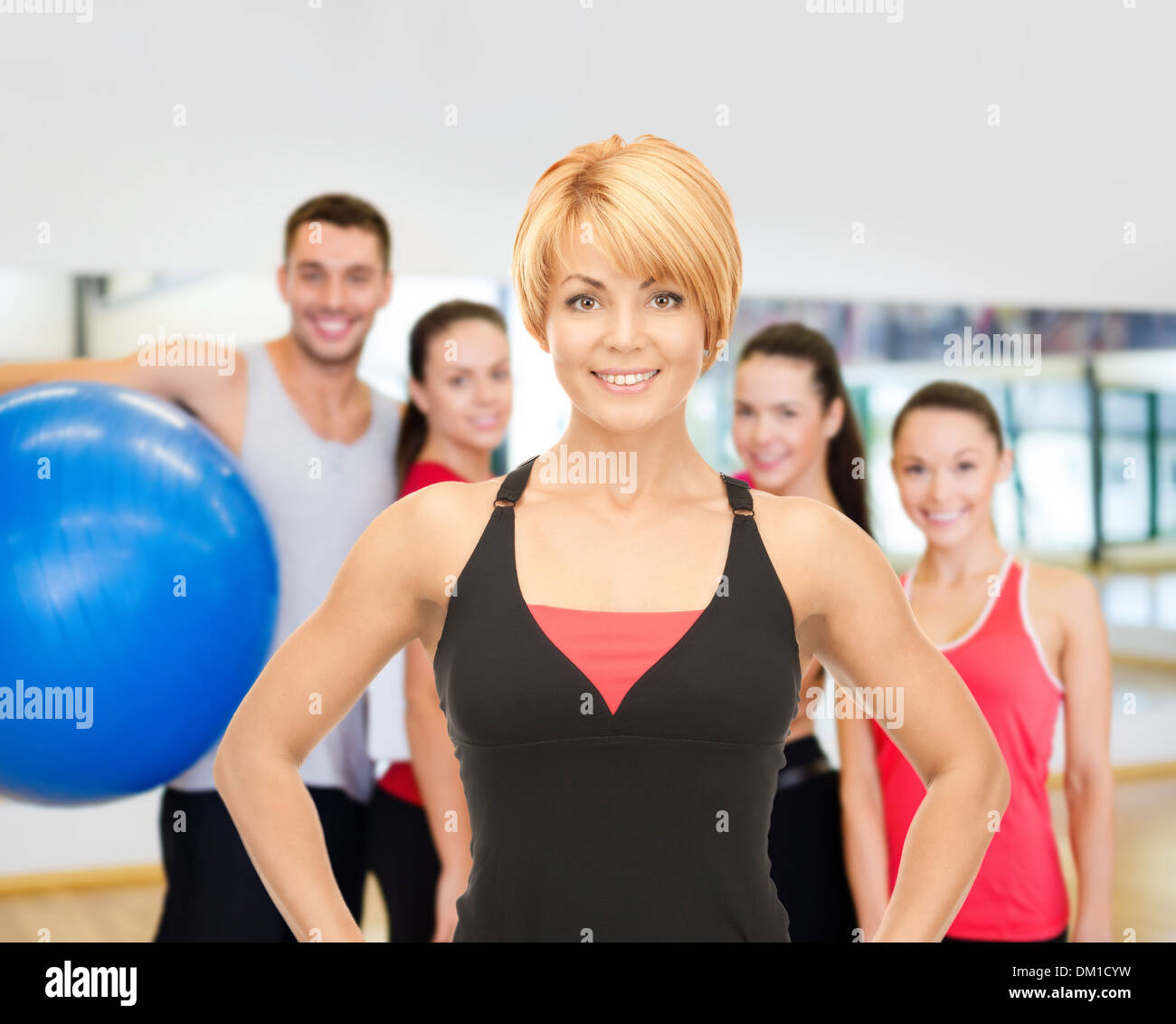 group of smiling people exercising in the gym Stock Photo - Alamy