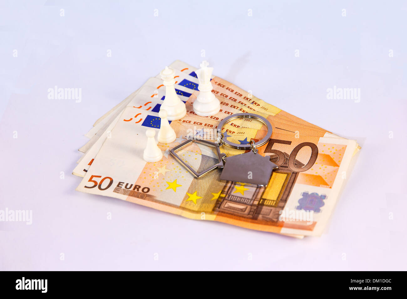 Banknotes of fifty euro isolated on white background with house-shaped ...