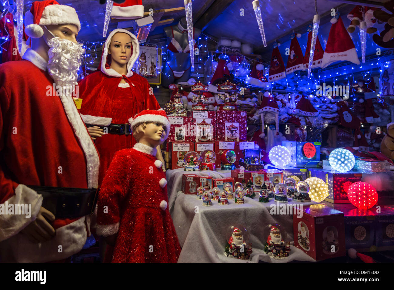Santa Claus clothes and decorations in Xmas market stall at evening ...
