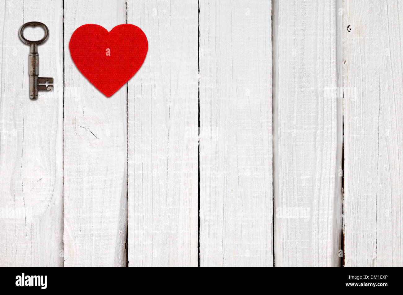 Red heart and key on white wooden background Stock Photo - Alamy
