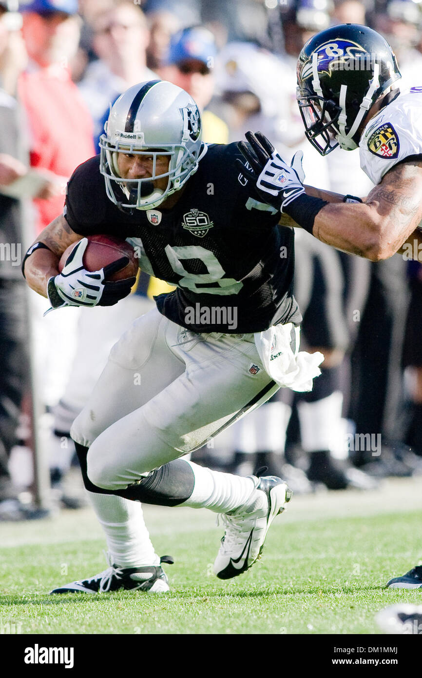 Oakland Raiders' Louis Murphy (18) is tackled by Ravens safety Dawan ...