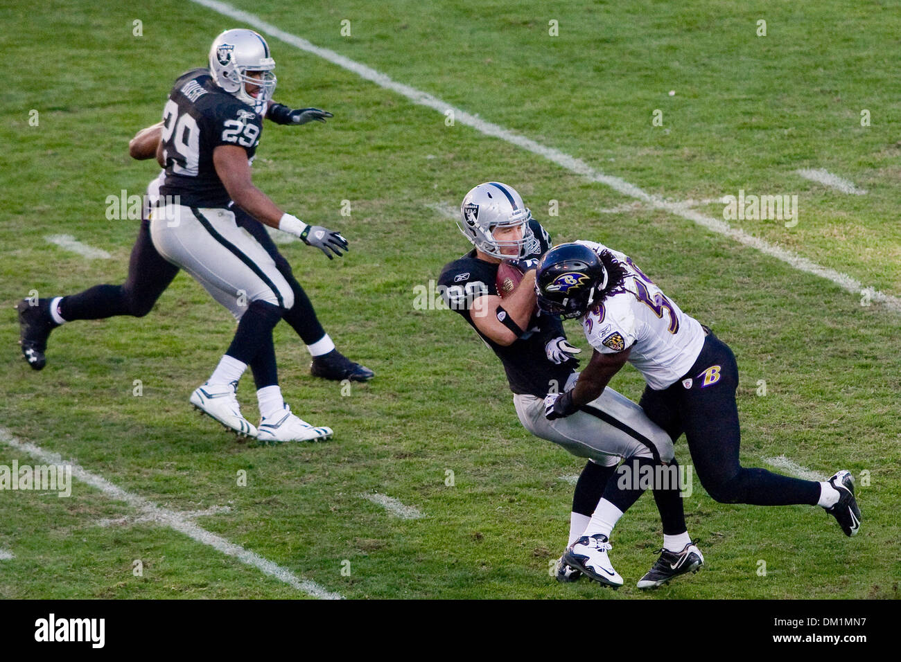 Oakland Raiders' Zach Miller (80) is tackled by Ravens linebacker ...