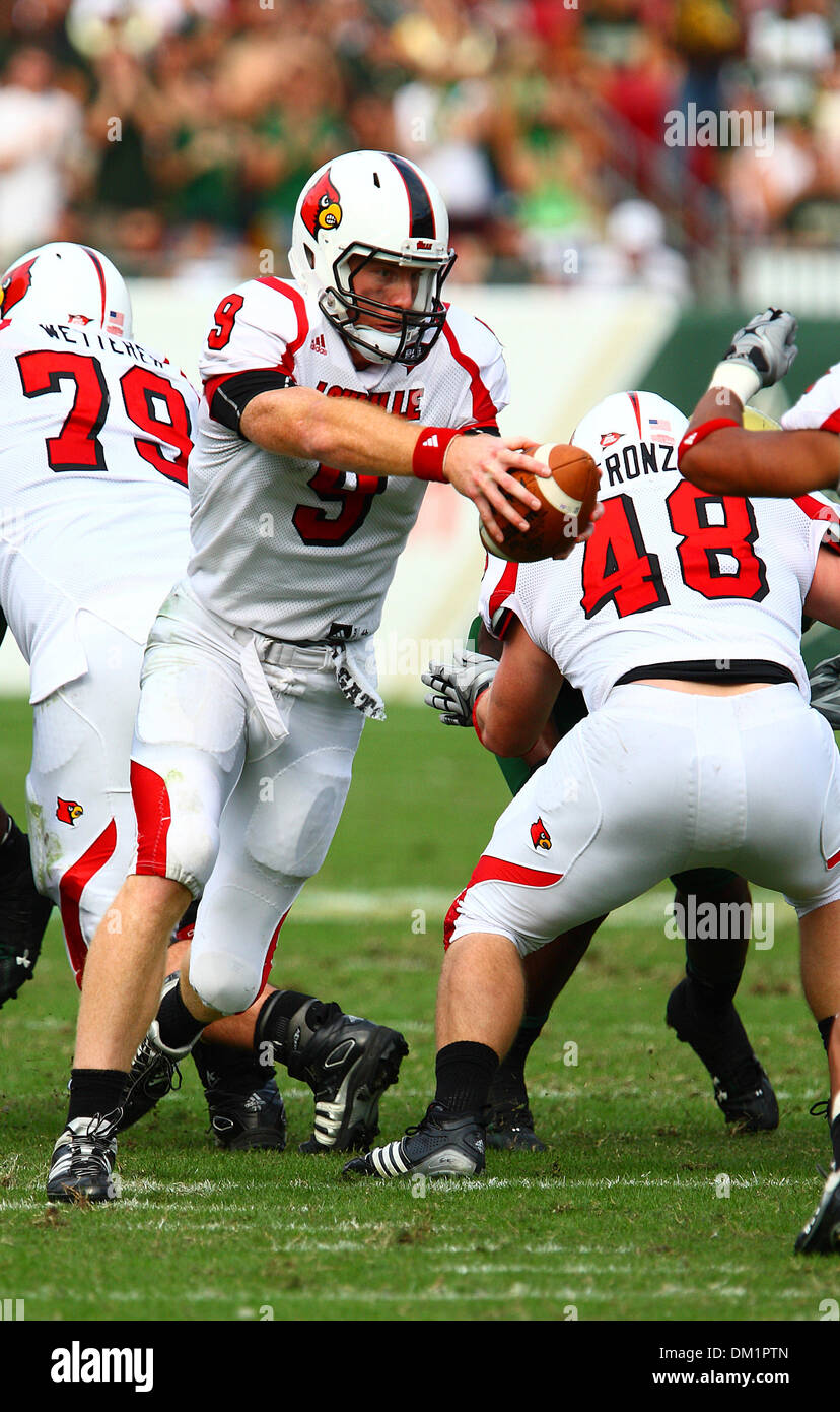 Louisville quarterback Adam Froman #9 hands off the ball during the ...