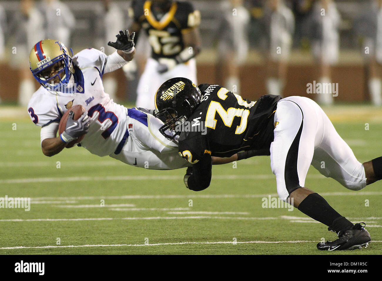 Southern Miss linebacker Martez Smith (32) puts a big hit on Tulsa wide ...