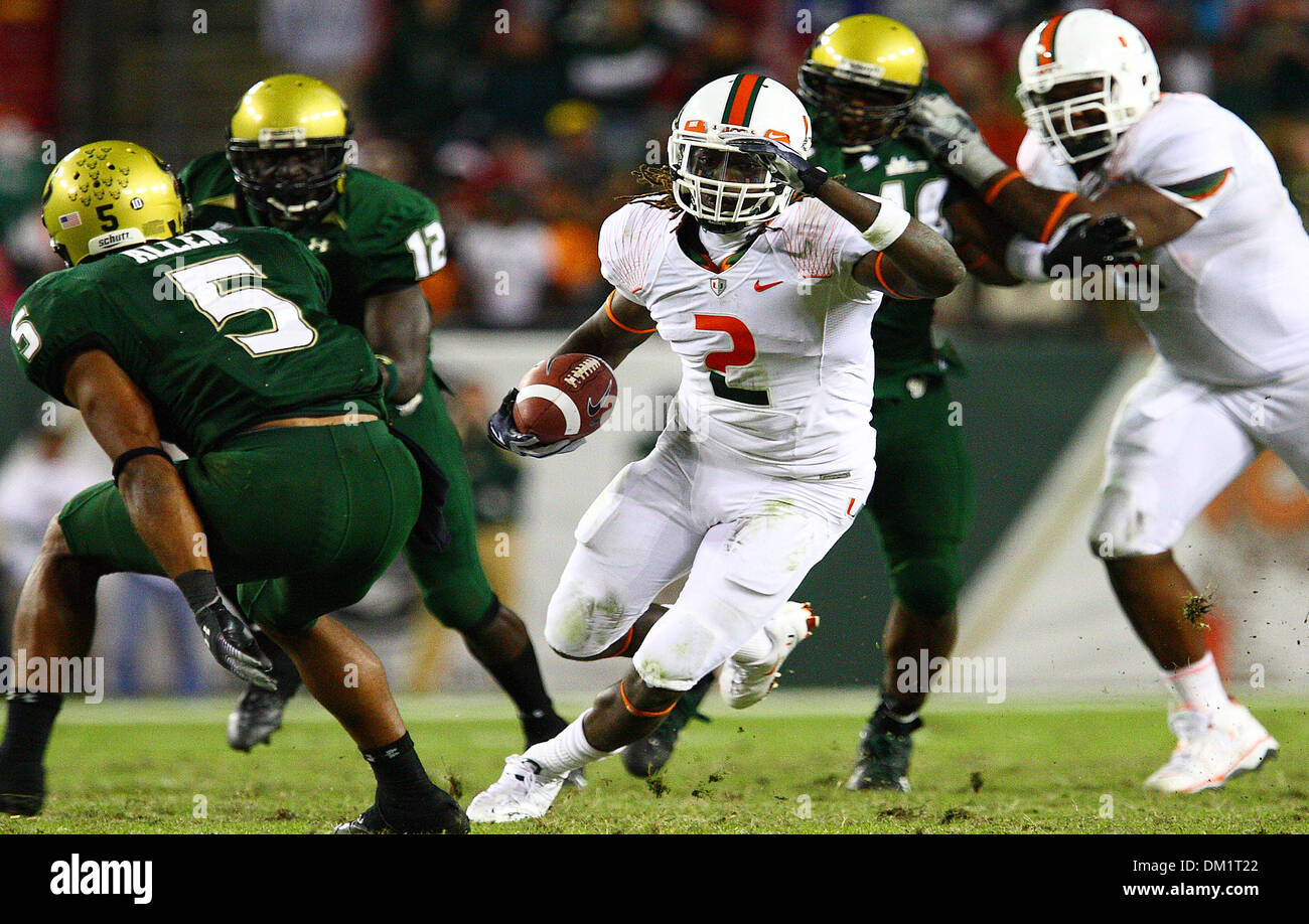 Miami (FL) running back Graig Cooper #2 runs by South Florida defenders ...