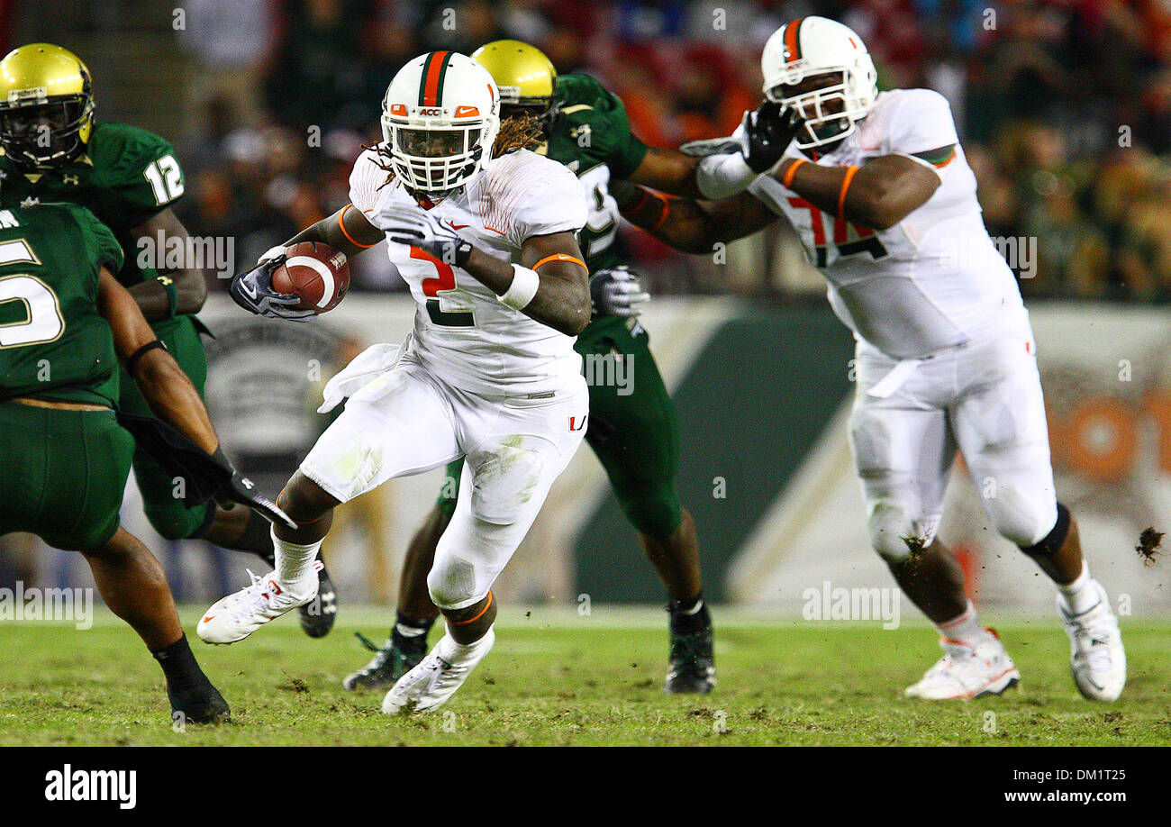 Miami (FL) running back Graig Cooper #2 runs by South Florida defenders ...