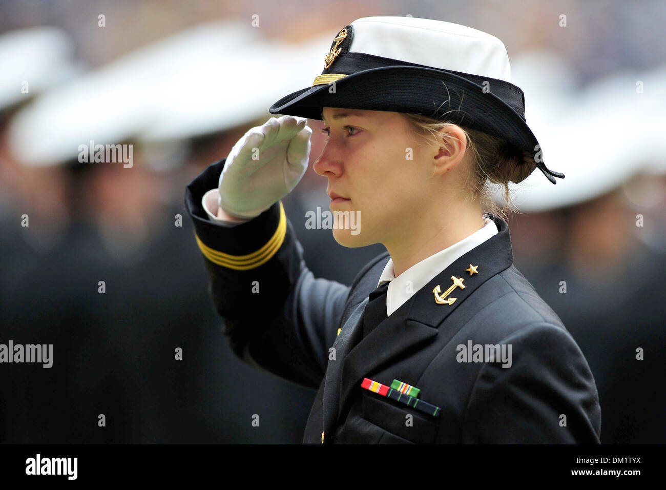 A Navy cadet during the playing of the National Anthem before the NCAA ...