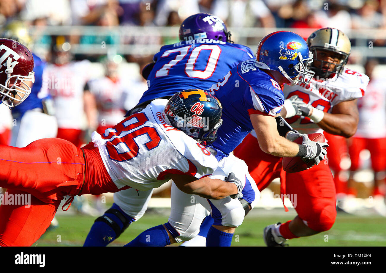 West team's quarterback Todd Reesing #8 is taken down by Greg Hardy Jr ...
