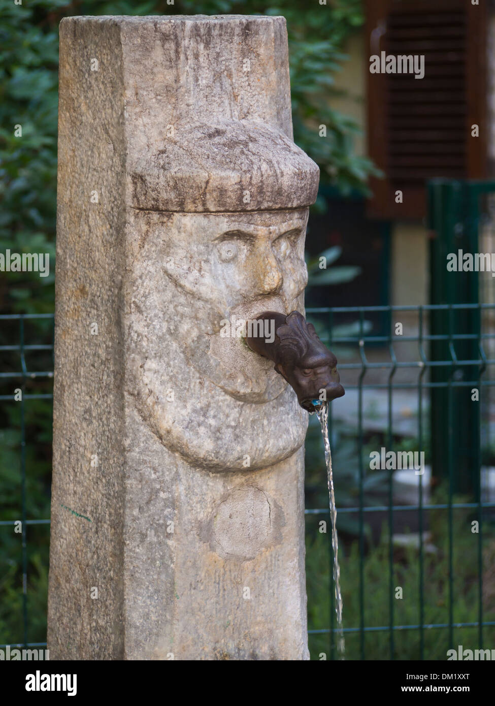 Fountain in stone, mans face with animal head sprout, old Annecy France ...