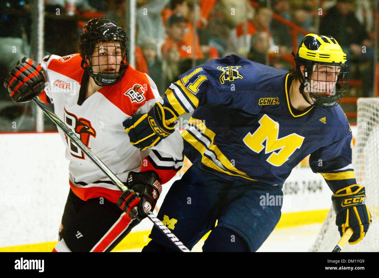 Michigan right winger Kevin Lynch (11) and Bowling Green defenseman Max ...