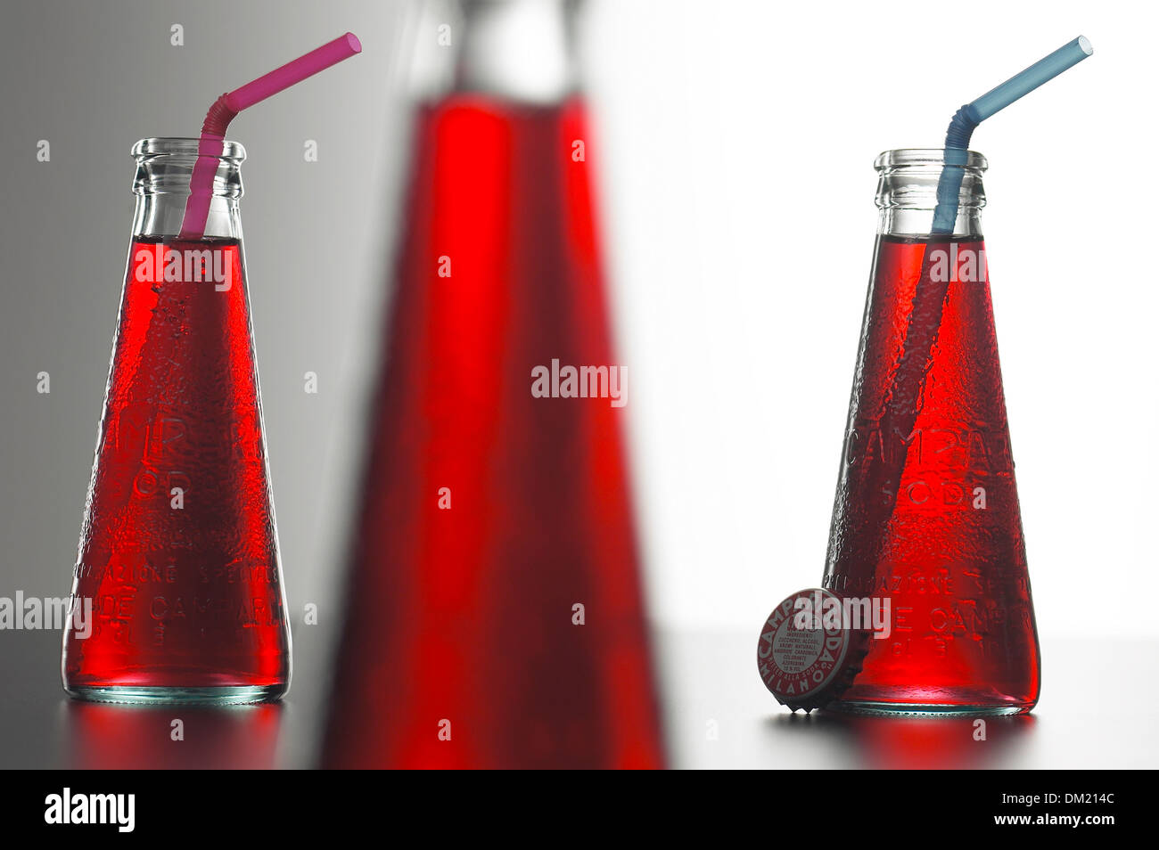 Three small Red Campari and Soda bottles on reflective background Stock ...