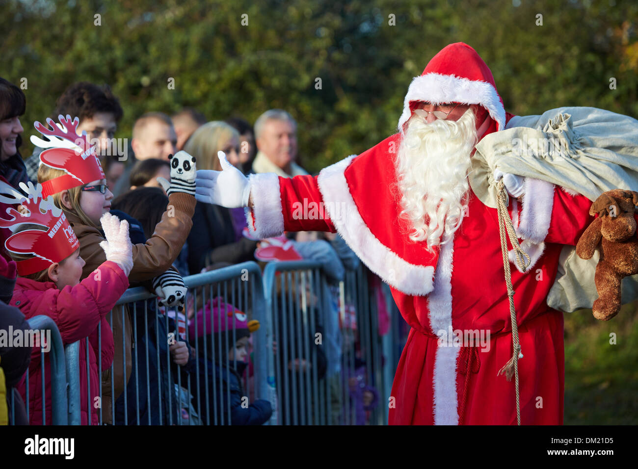 Santa Claus gives a high five to waiting children after arriving by ...