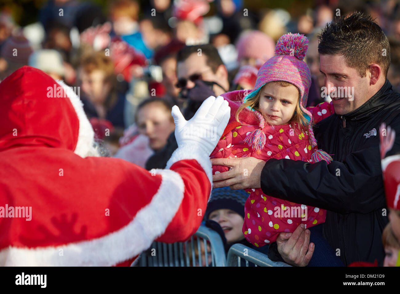 Santa Claus gives a high five to waiting children after arriving by ...
