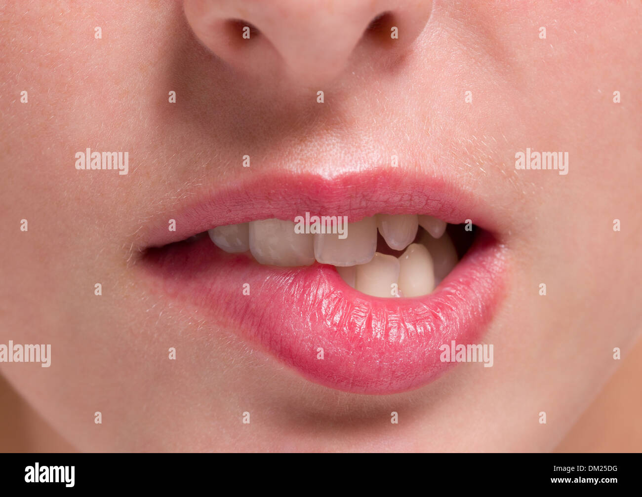 mouth closeup of a woman bites on her lips Stock Photo - Alamy