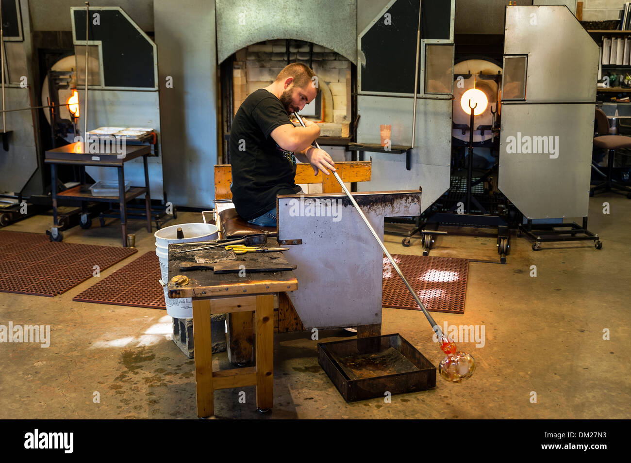 Glassblower working on a piece Stock Photo - Alamy