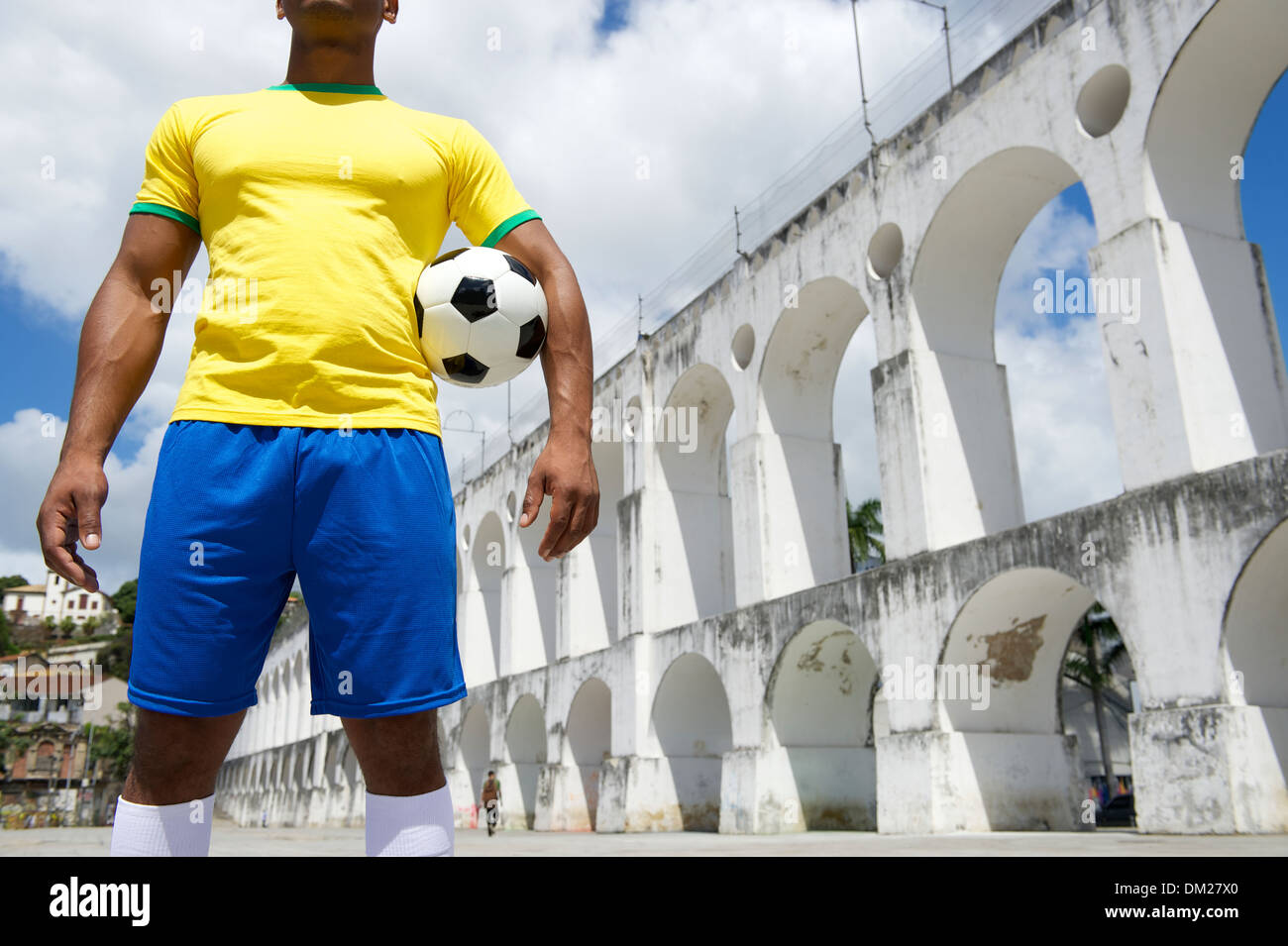 Brazilian football player holding soccer ball wears Brazil team colors ...