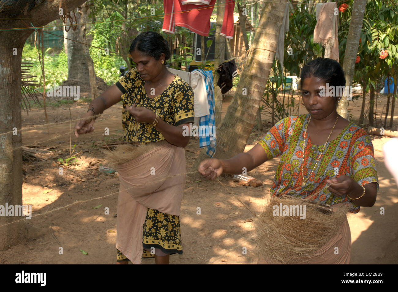 Indian women weaving course coconut fibres (coir) into string for ...