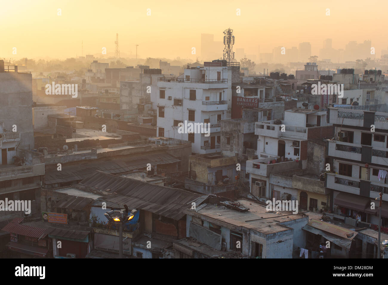 Late afternoon sun rays shine through haze of the Paharganj district of ...