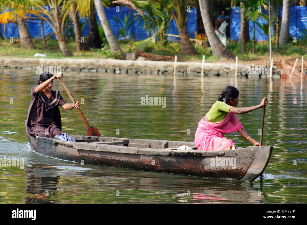 Two women rowing a canoe in the Kerala backwaters in India Stock Photo ...