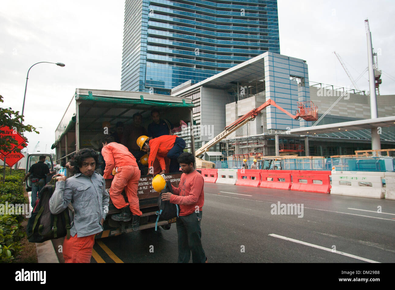Migrant workers arrive for their shift on construction sites in the ...