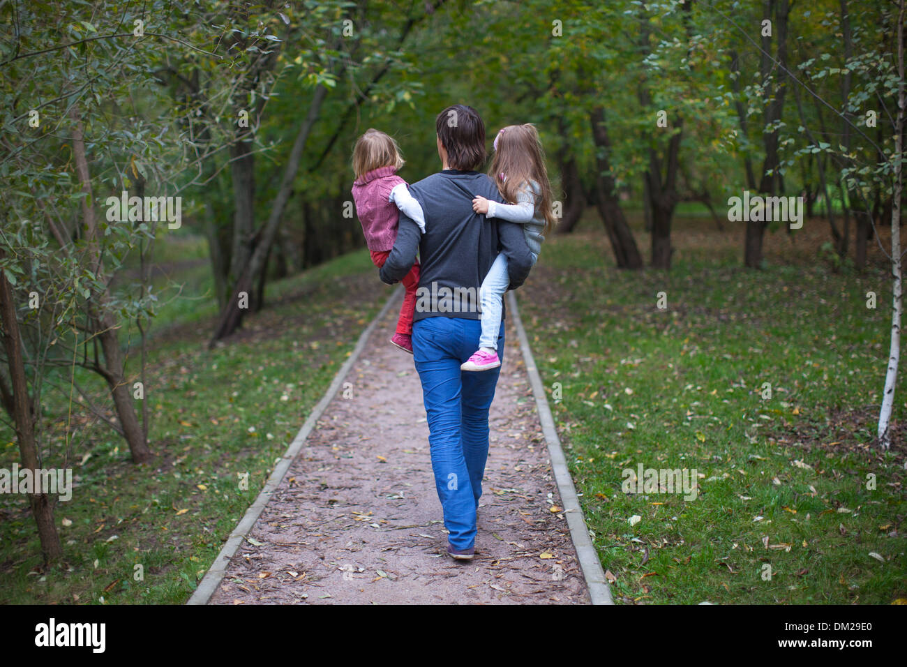 Back view of father and his two little daughters outdoor Stock Photo ...
