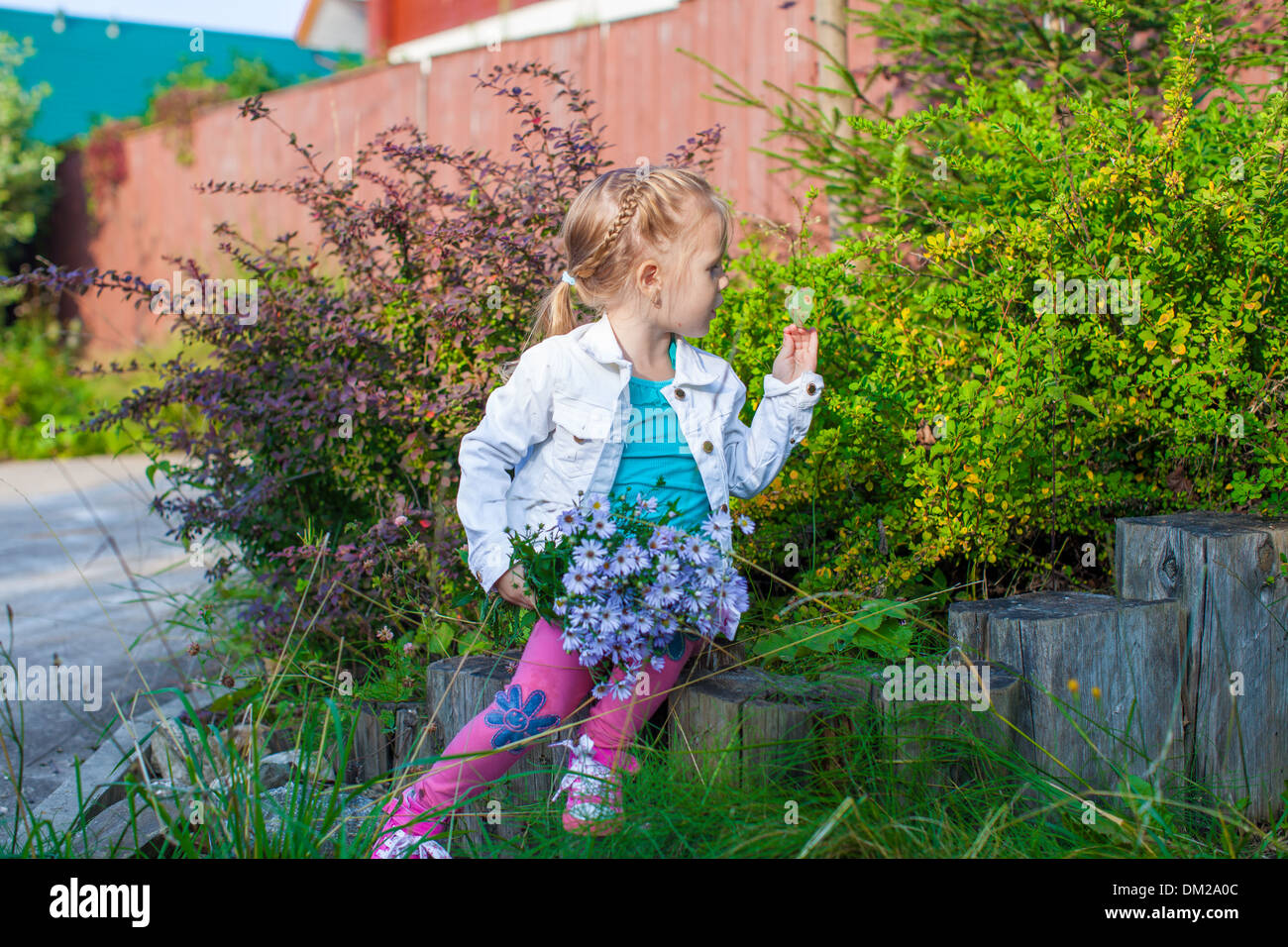 Little cute girl walking with a bouquet of flowers Stock Photo - Alamy