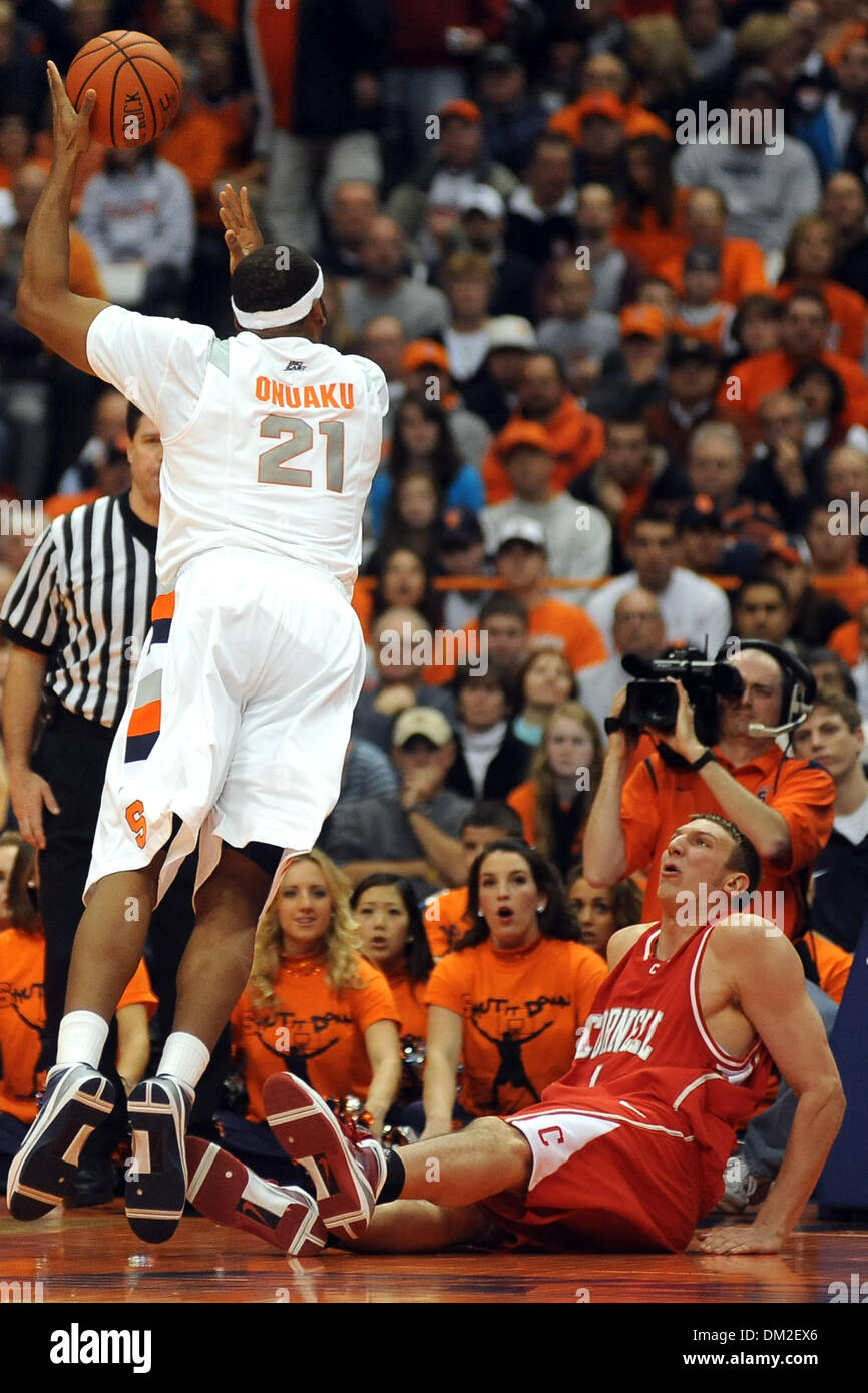 Cornell center Jeff Foote watches Syracuse center Arinze Onuaku (21 ...