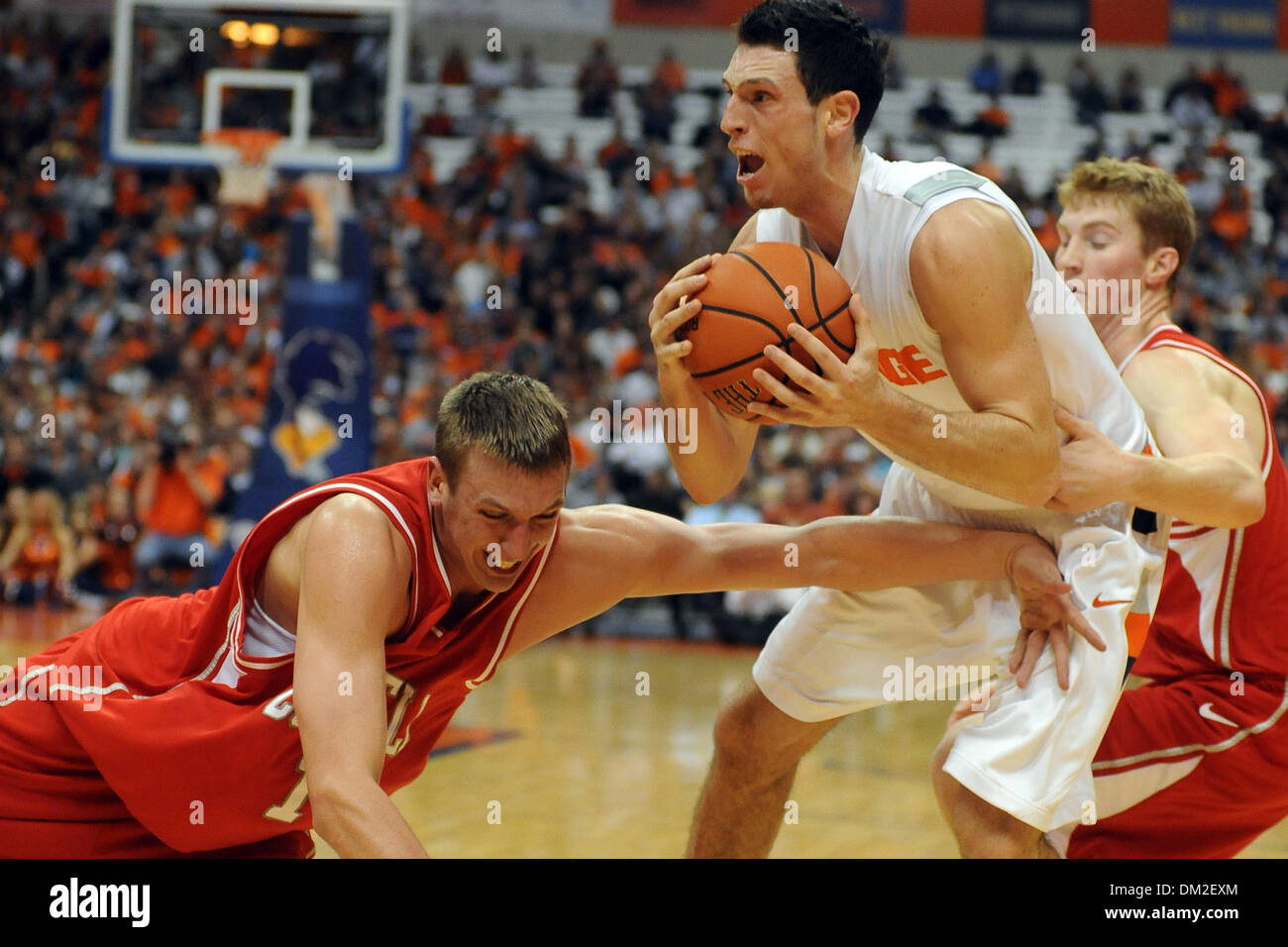 Syracuse guard Andy Rautins (middle) is fouled by Cornell center Jeff ...