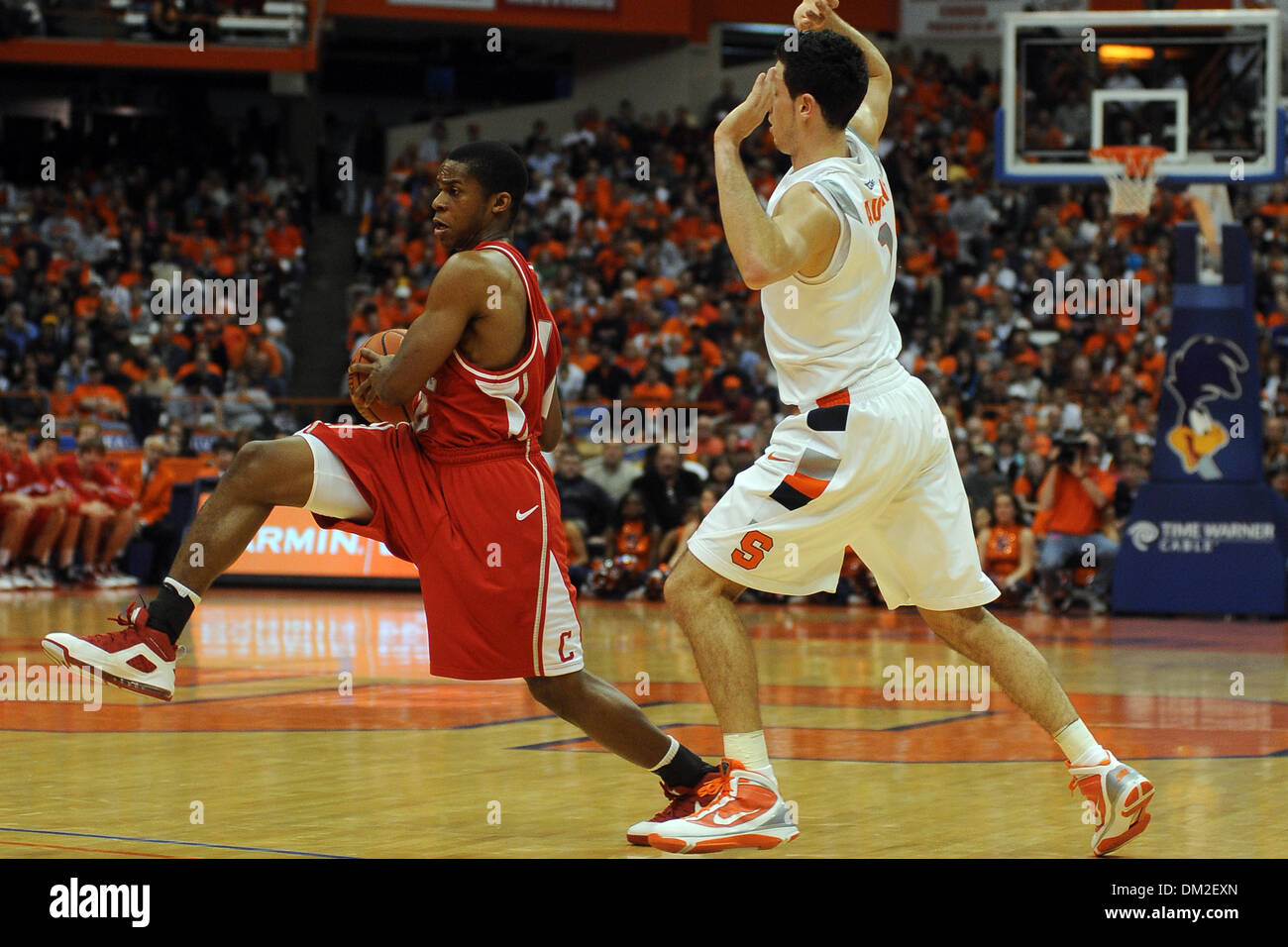 Cornell guard Louis Dale (left) takes a step around Syracuse guard Andy ...
