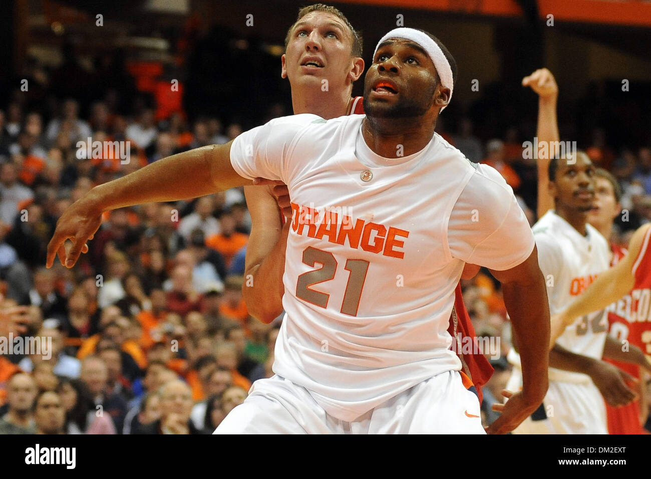 Syracuse center Arinze Onuaku (21) boxes out Cornell center Jeff Foote ...