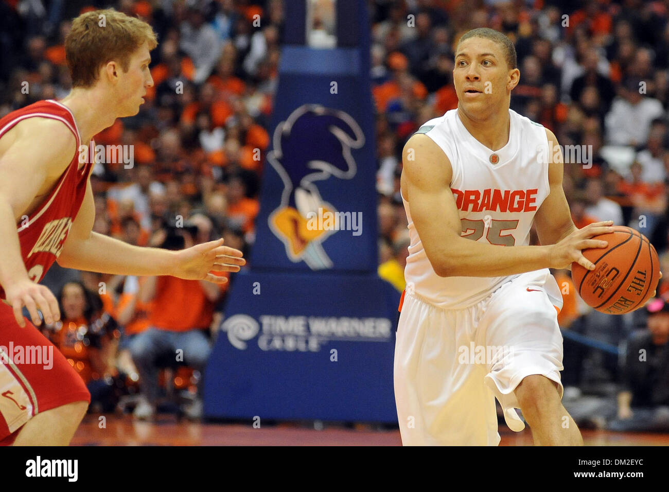 Syracuse guard Brandon Triche (25) looks to get around Cornell guard ...