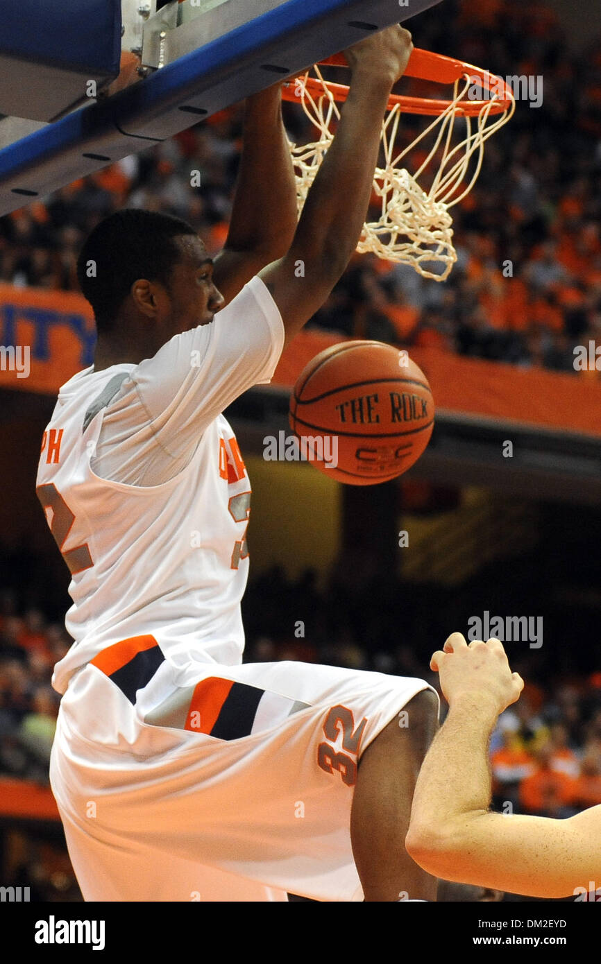Syracuse forward Kris Joseph (32) hangs on the rim following the ally ...