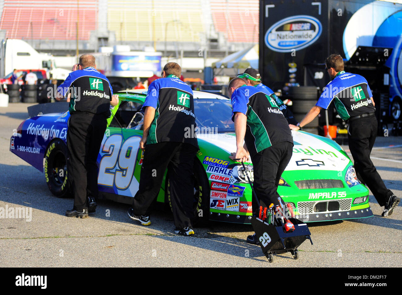 The crew of the 29 Holiday Inn Nationwide Series car pushes it through ...