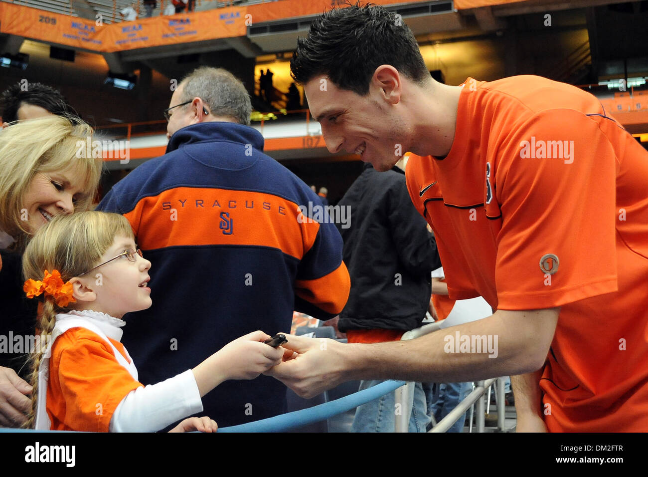 Syracuse guard Andy Rautins (right) takes a pen from a young fan to ...