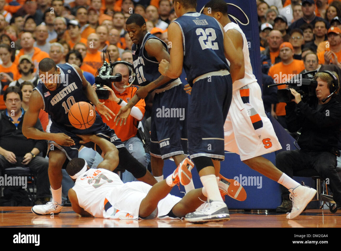 Georgetown center Greg Monroe (10) tries pick up the loose ball from ...