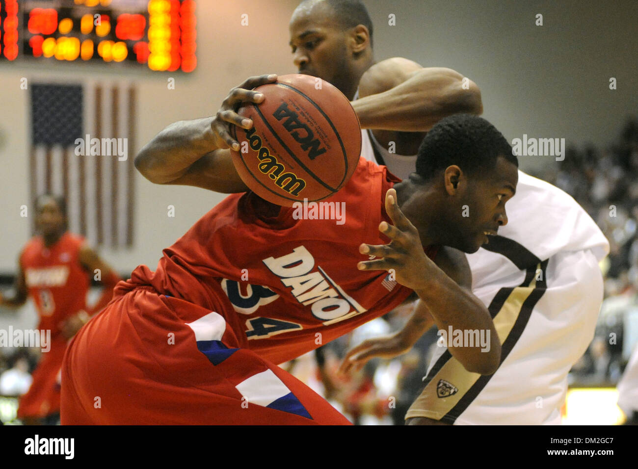 Dayton forward/center Devin Searcy (34) drives to the hoop in the first ...