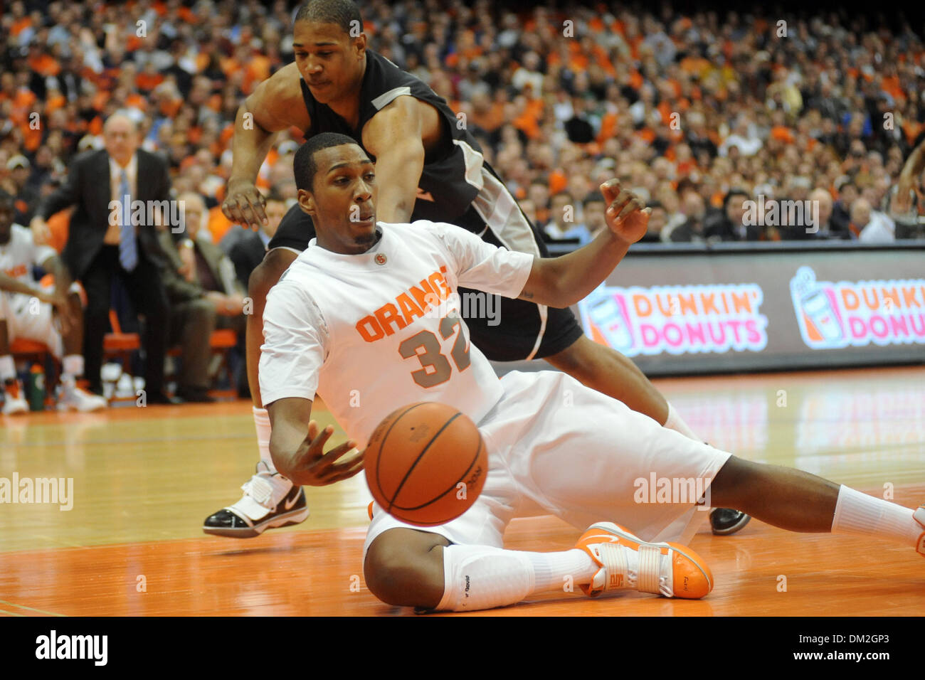 Syracuse forward Kris Joseph (32) dives to save the loose ball in the ...