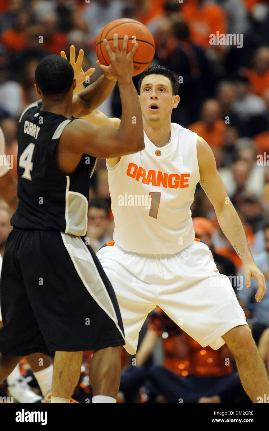 Syracuse guard Andy Rautins (1) sticks a hand in the face of Providence ...