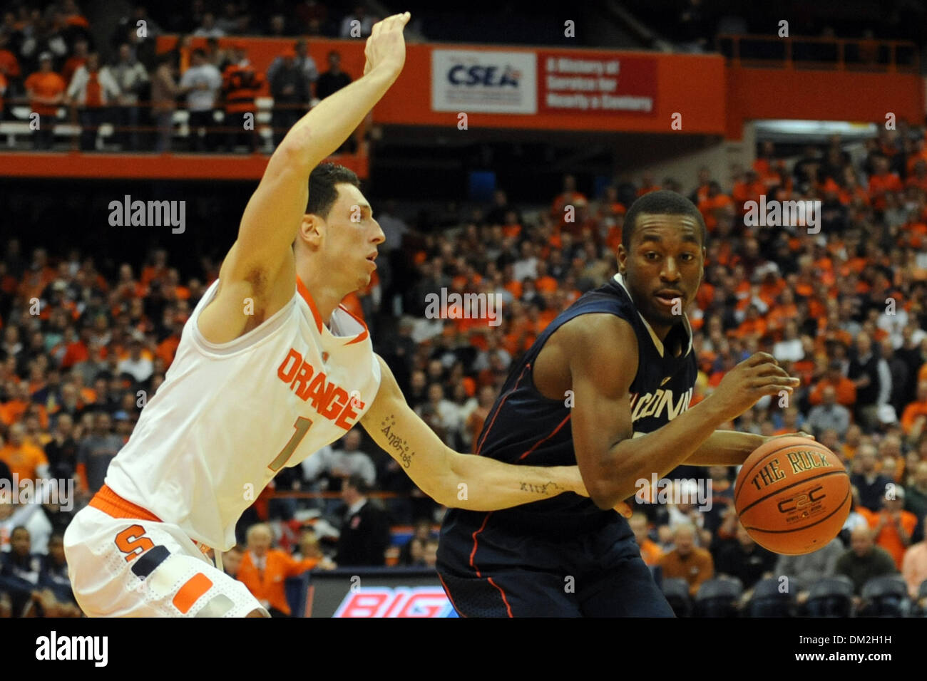 Connecticut guard Kemba Walker (right) tries to drive around Syracuse ...