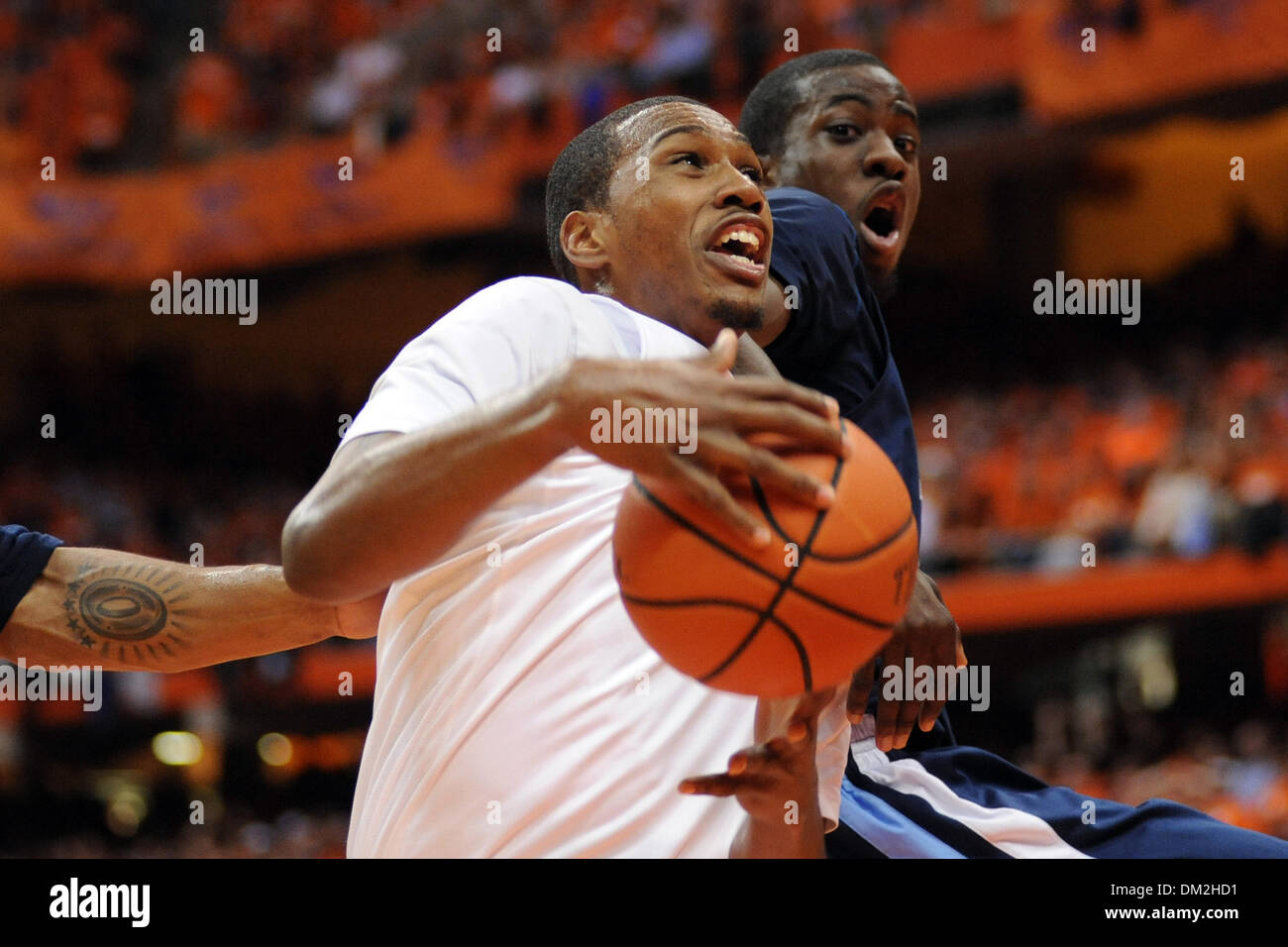 Syracuse forward Kris Joseph (front) is fouled by Villanova forward ...