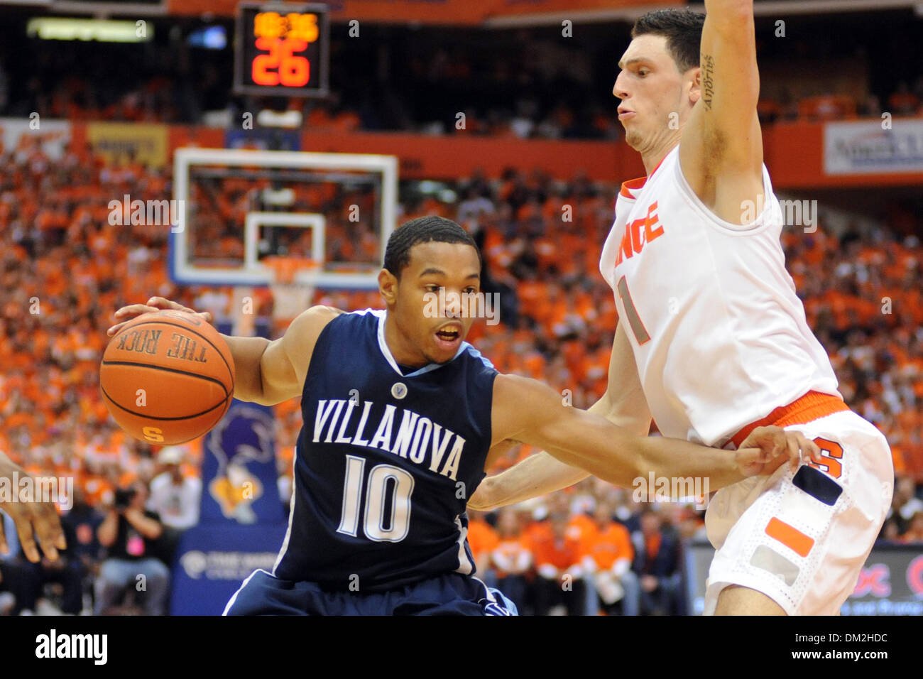 Villanova guard Corey Fisher (10) pushes off of Syracuse guard Andy ...