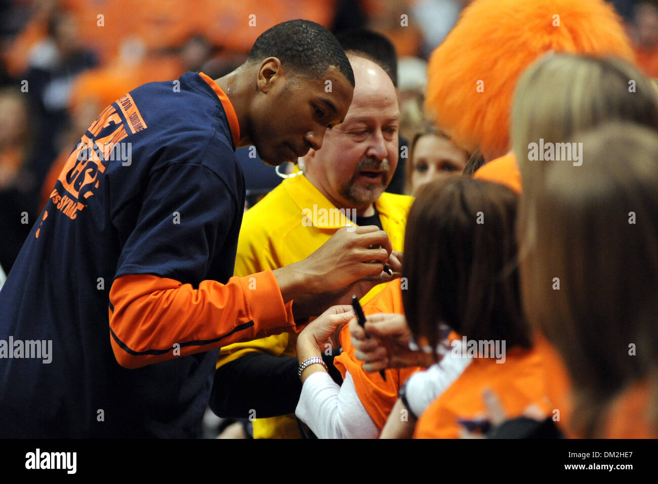 Syracuse forward Wesley Johnson (4) signs autographs during warm-ups ...
