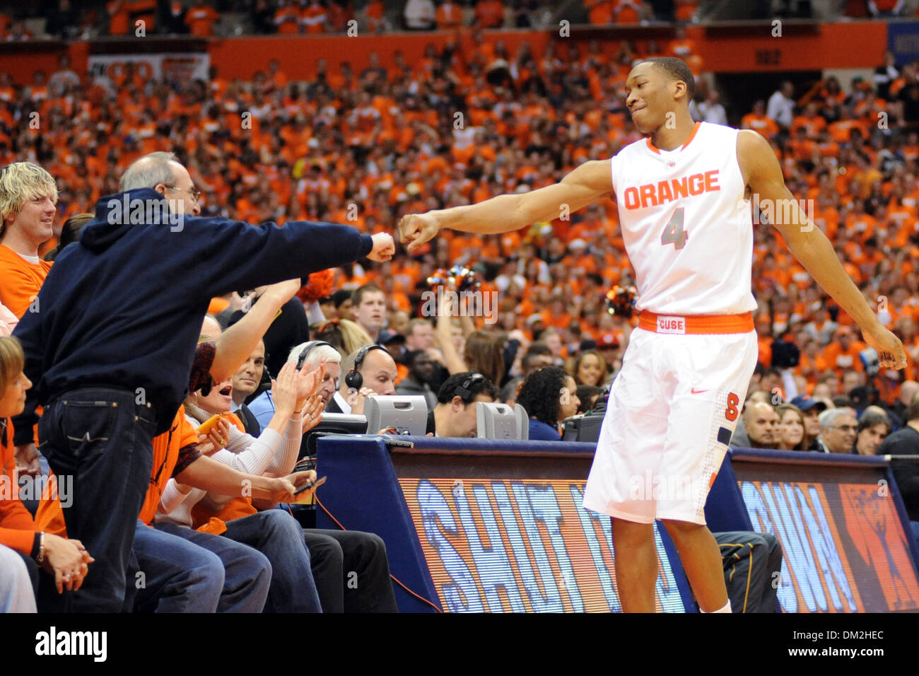 Syracuse guard Andy Rautins (1) fist bumps a fan before the opening tip ...