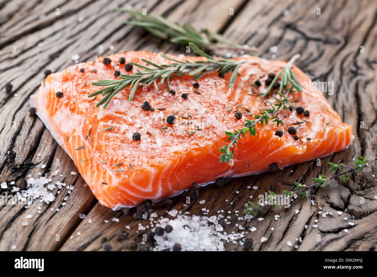 Salmon fillet with spices on a wooden carving board. Macro shot Stock ...