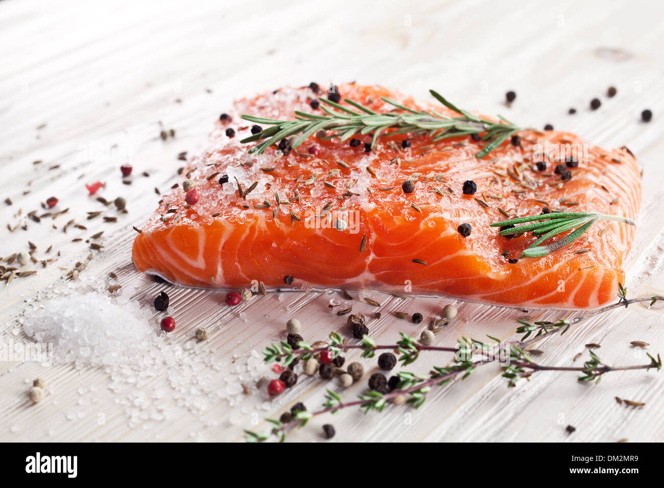 Salmon fillet with spices on a wooden carving board. Macro shot Stock ...