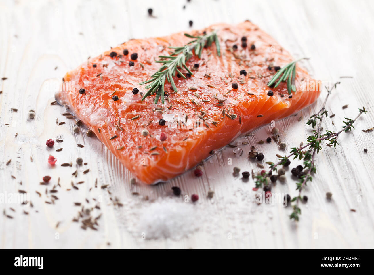 Salmon fillet with spices on a wooden carving board. Macro shot Stock ...