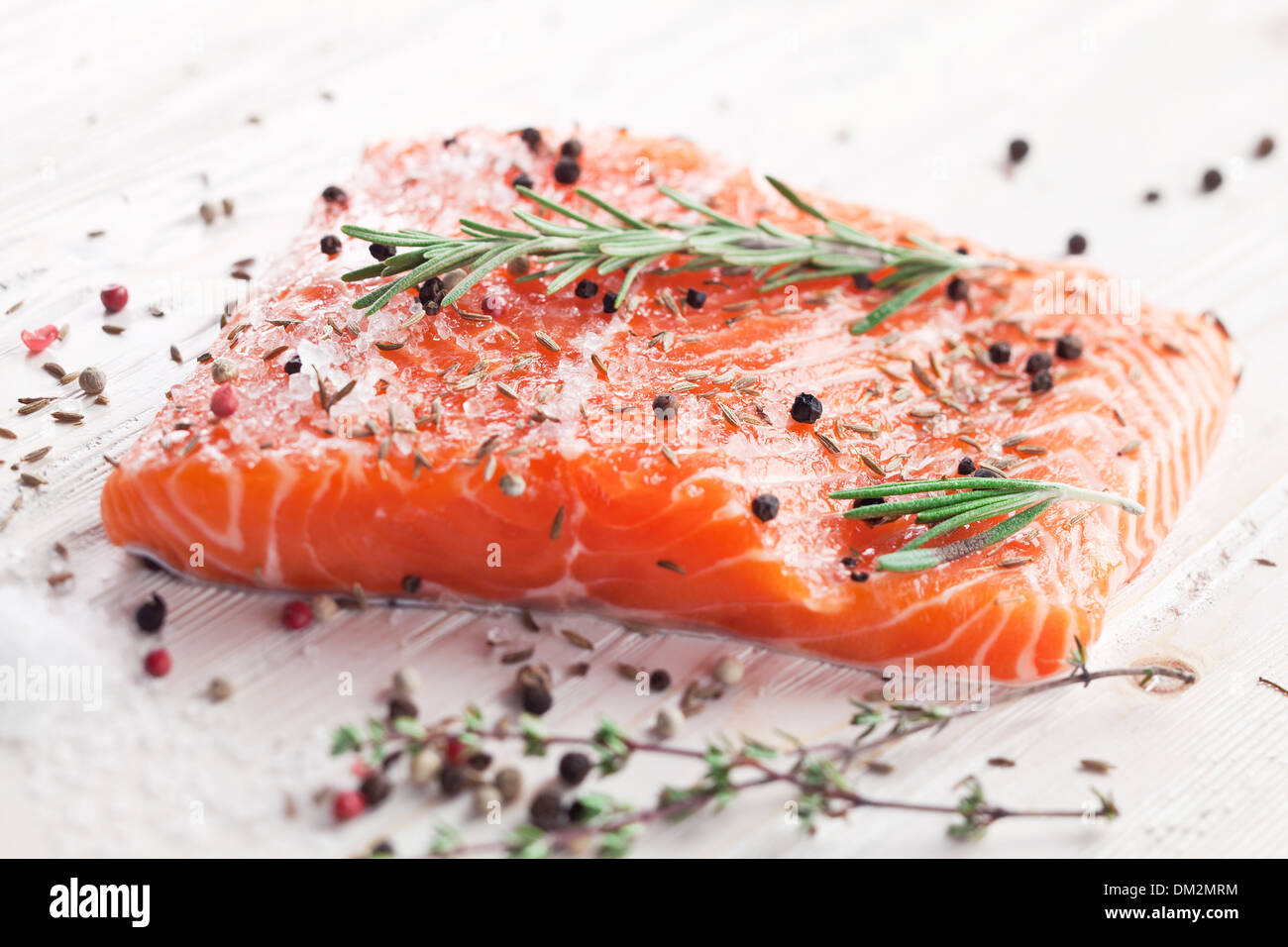 Salmon fillet with spices on a wooden carving board. Macro shot Stock ...