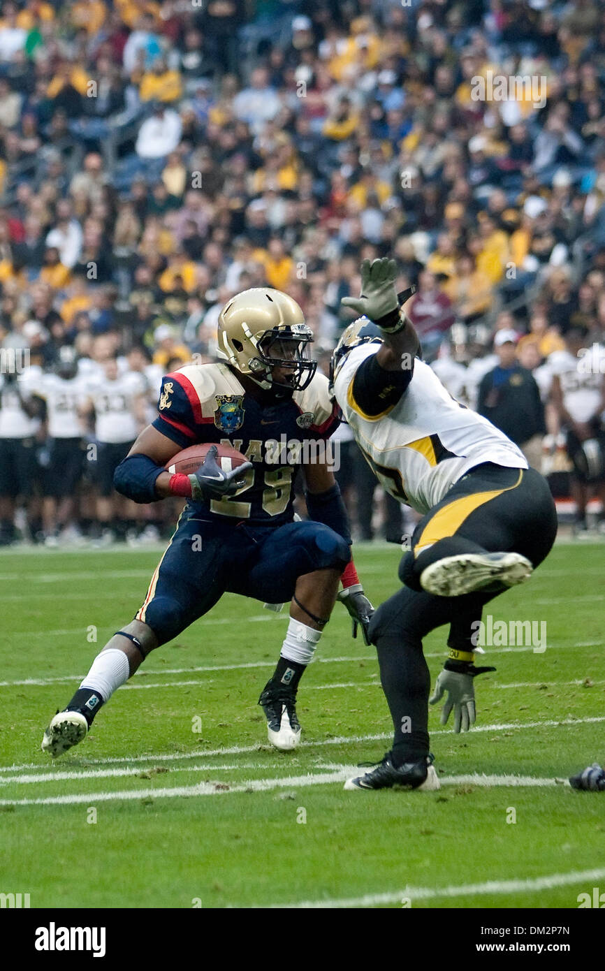Navy running back Marcus Curry cuts inside to elude a Missouri defender ...