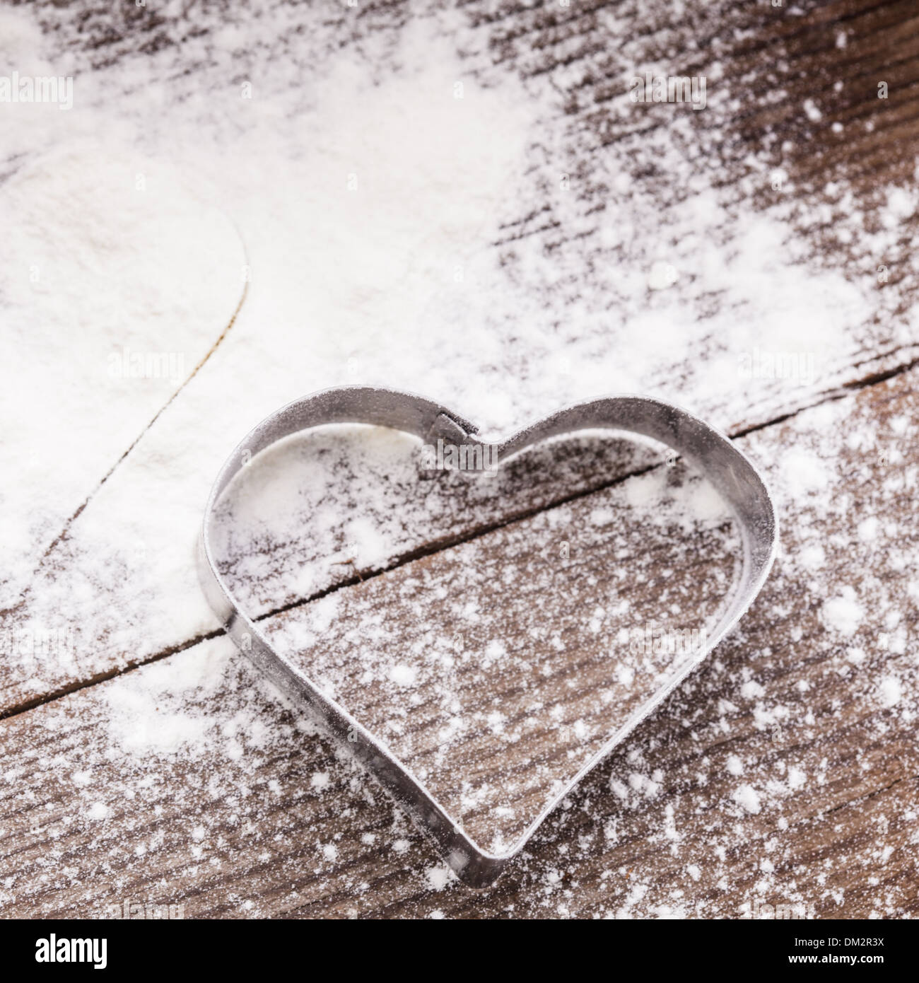 Cookie cutter heart shape on the kitchen table and flour Stock Photo ...