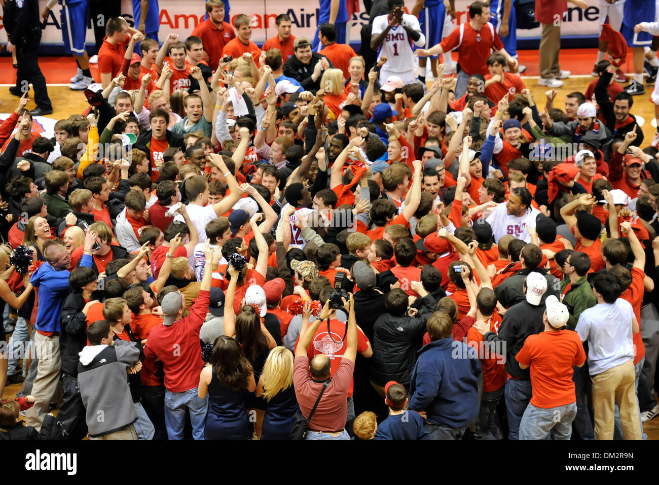 SMU fans rush the court after defeating the Memphis Tigers at Moody ...